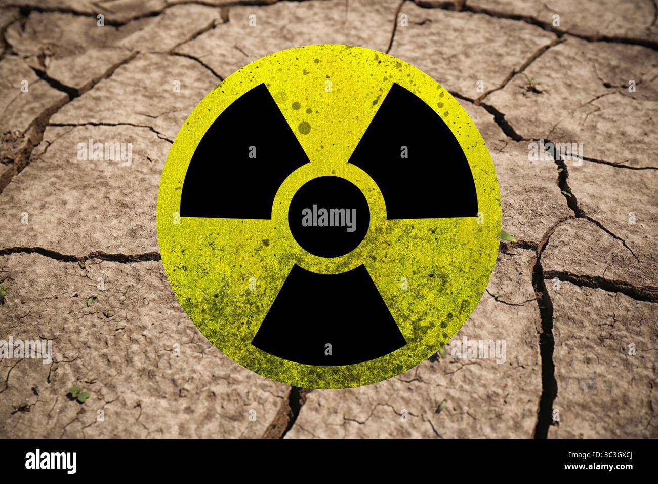 Yellow radioactive sign on cracked dry earth, closeup. Radiological ...