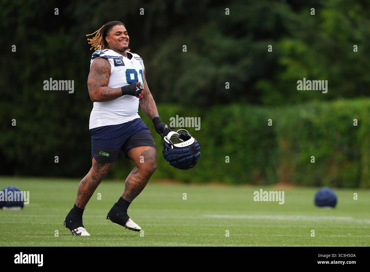 Seattle Seahawks defensive tackle Byron Murphy II smiles while warming ...