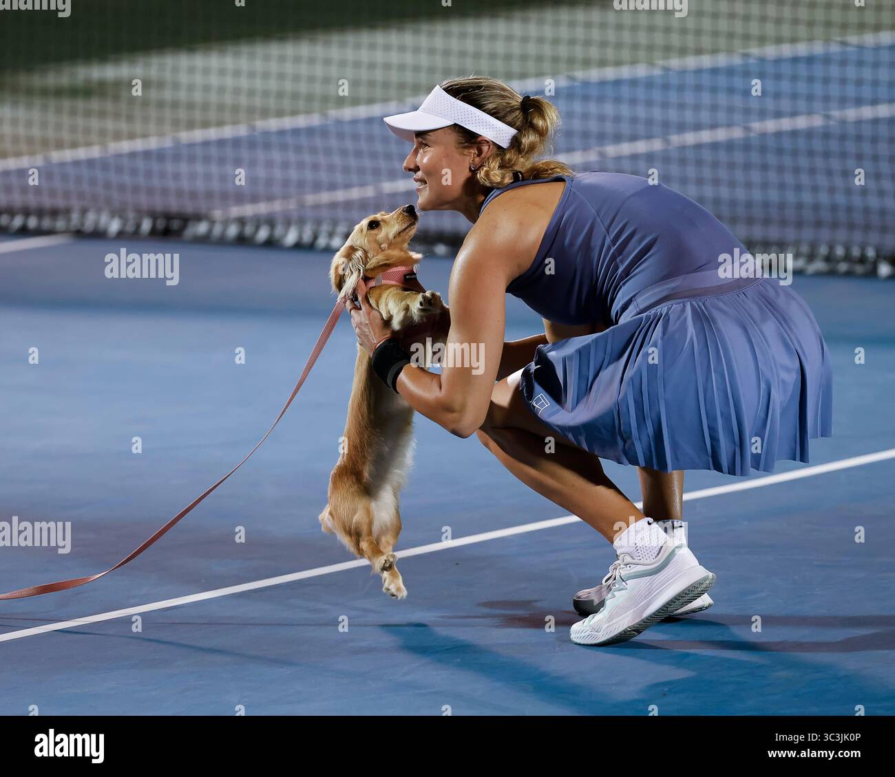 July 25, 2025: Anna Kalinskaya holds her dog after her match against ...