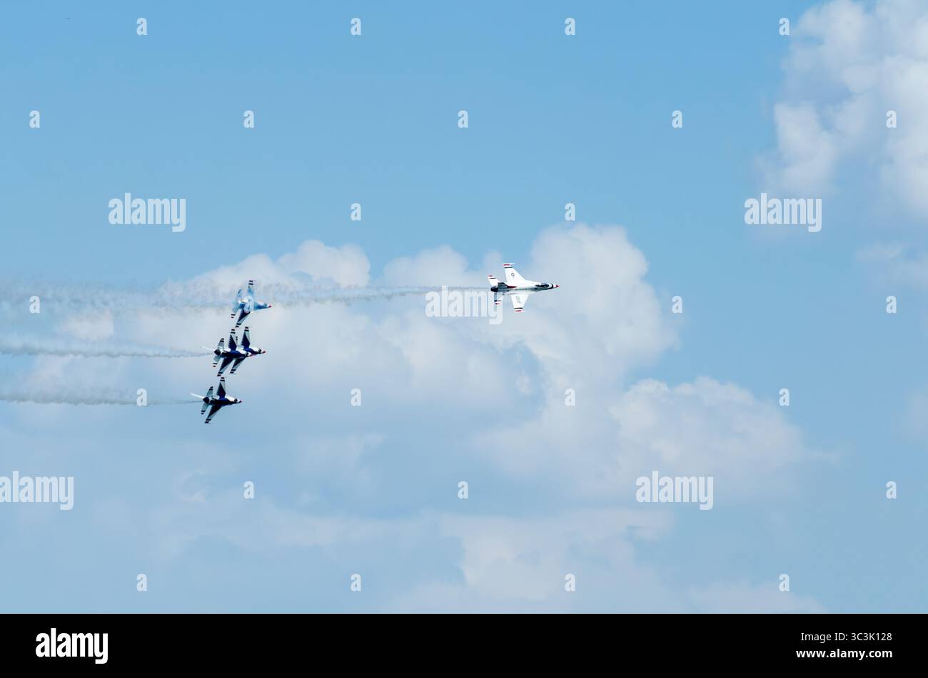 Four USAF Thunderbirds execute a crossover break maneuver during the ...