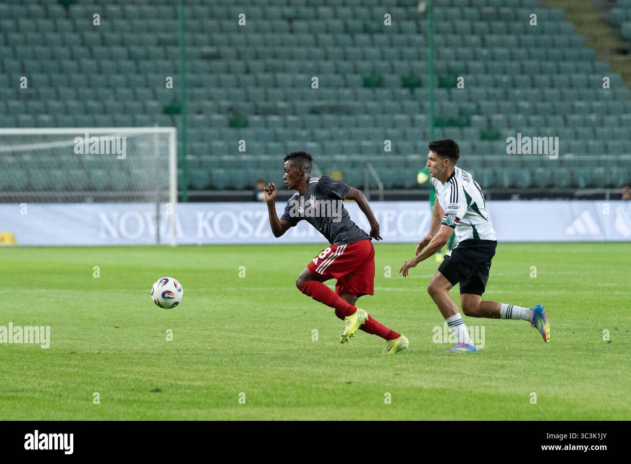 Jairo Jean of FC Aktobe and Bartosz Kapustka of Legia Warszawa are seen ...