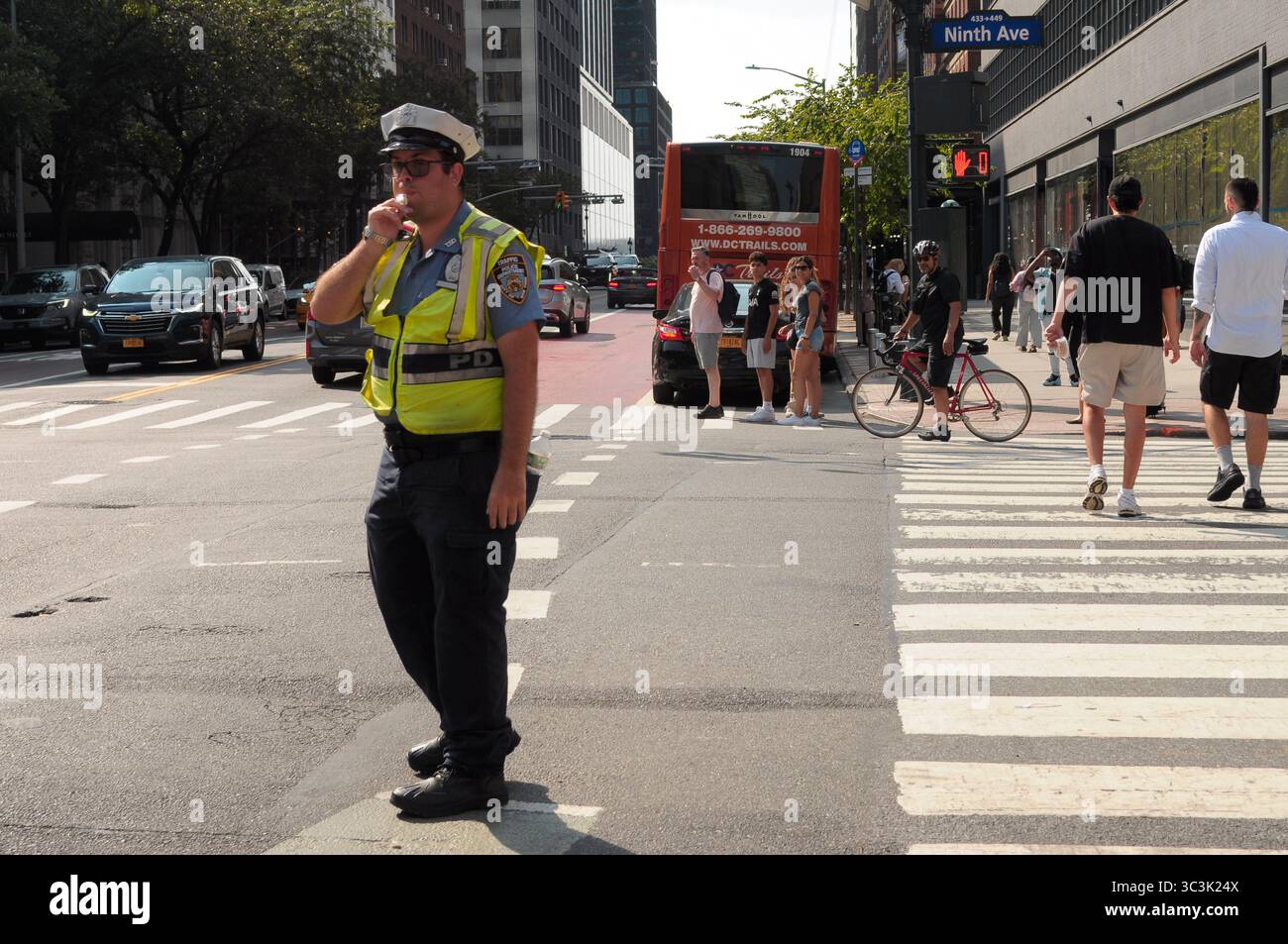 A New York City Police Department traffic officer directs traffic on ...