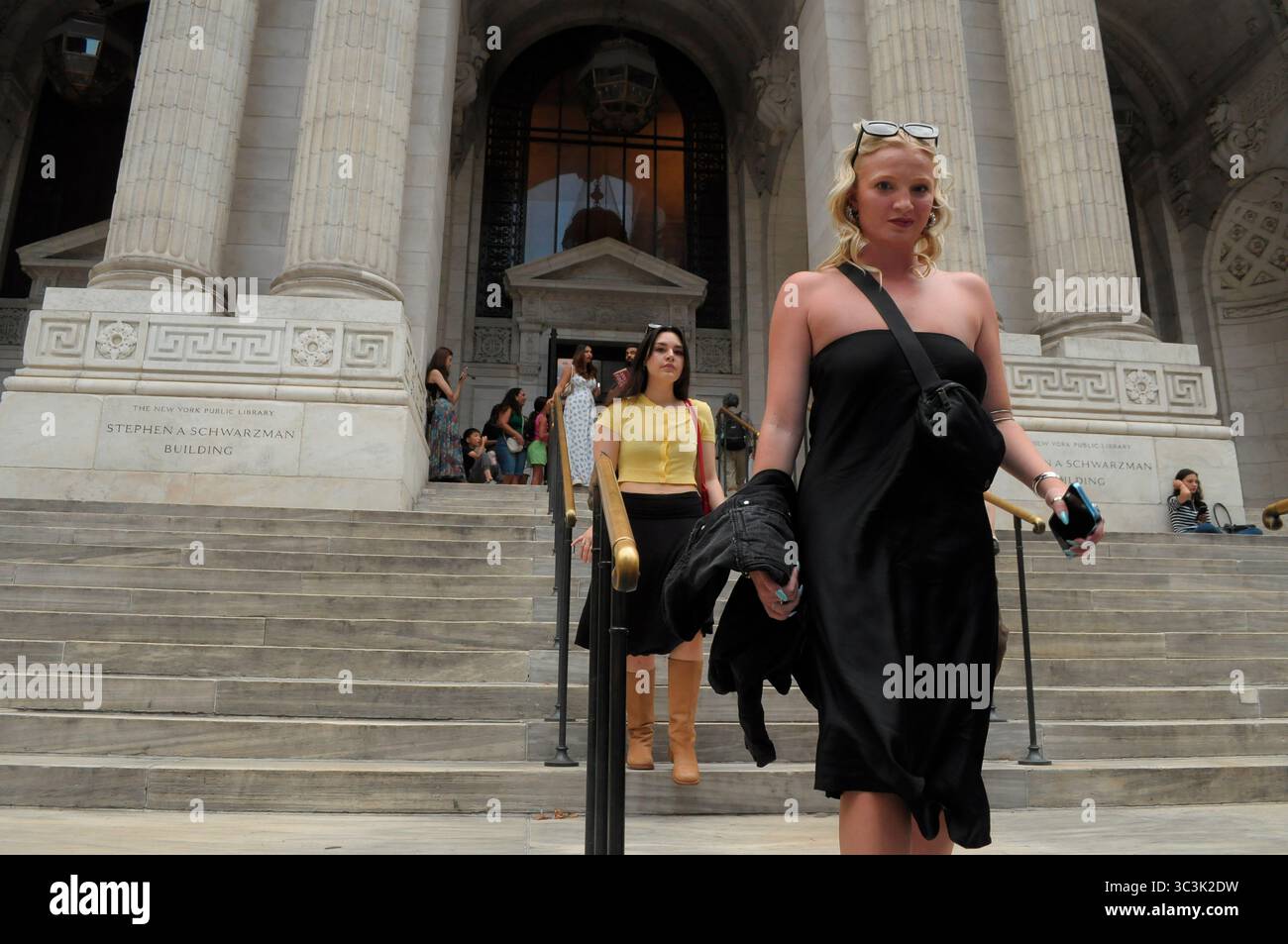 People walk on the stairs of the New York Public Library in Manhattan ...