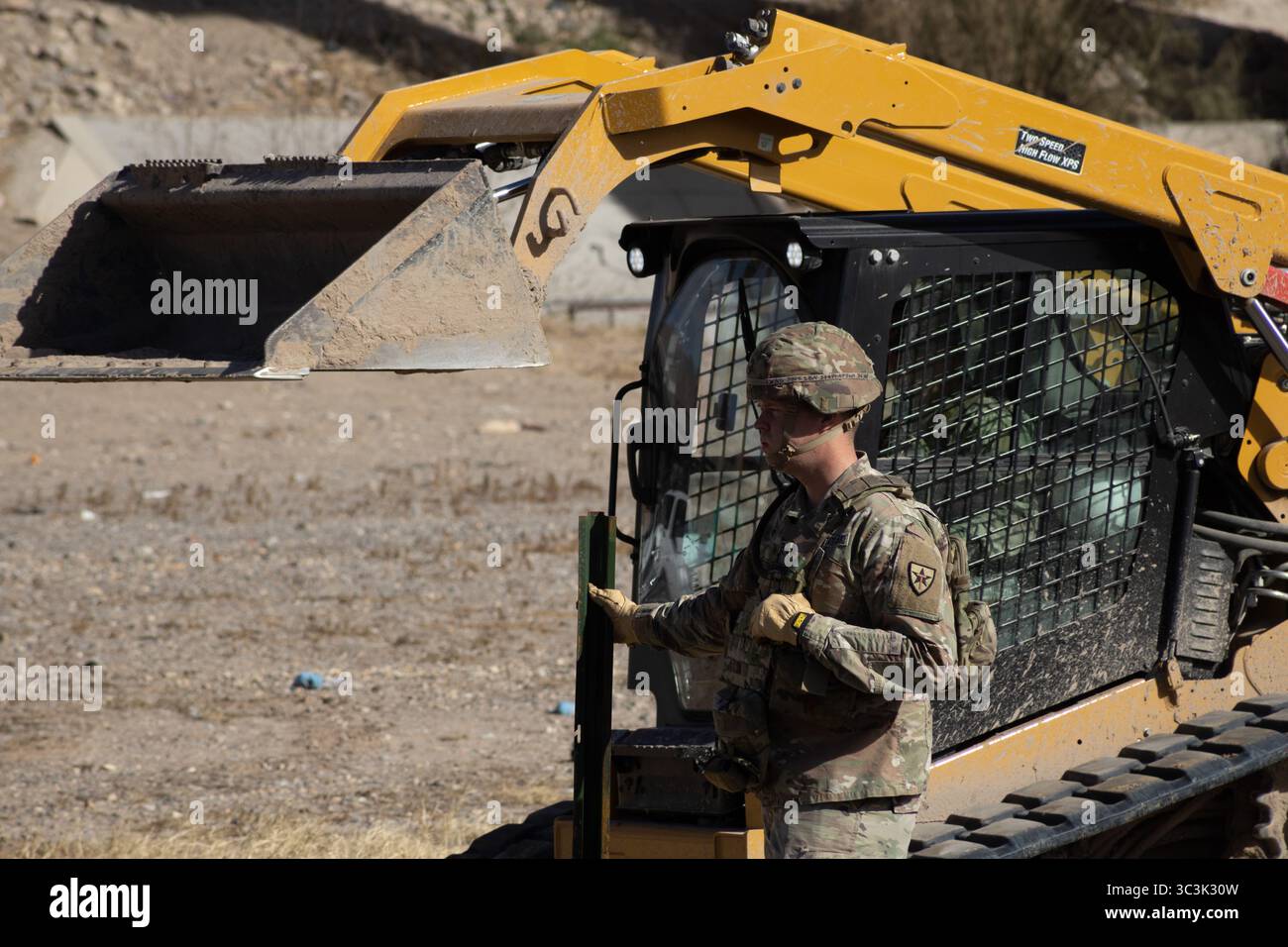 U.S. Army soldier skillfully maneuvers a skid steer loader for a ...