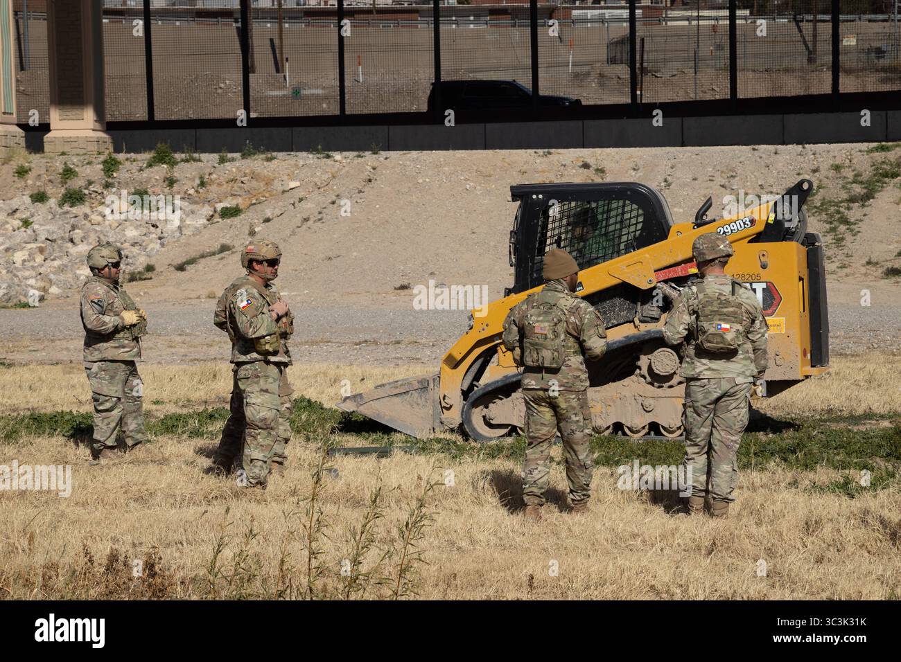 Military personnel oversee border security near a bulldozer in Ciudad ...