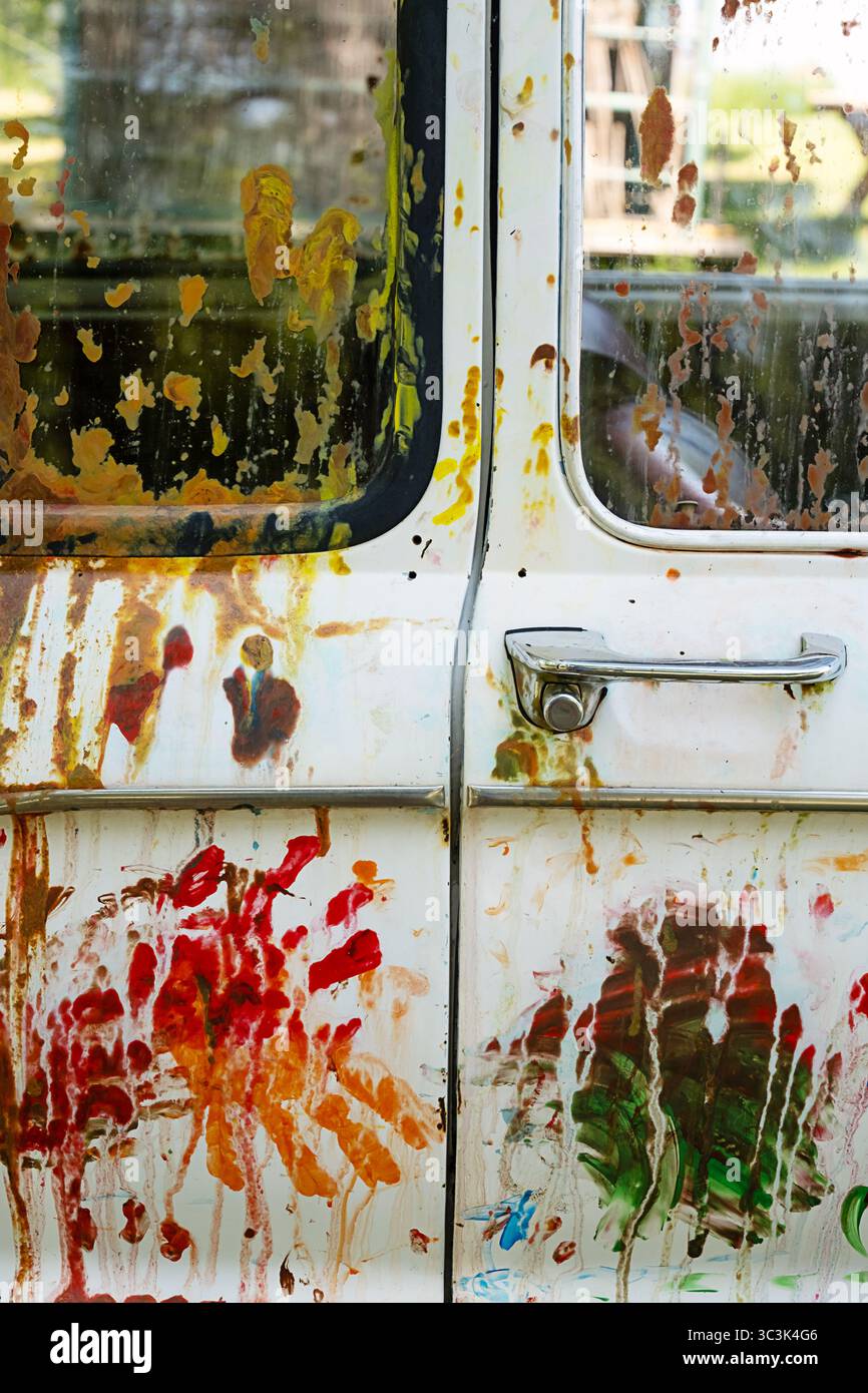 Old white car covered in colorful handprints and splashes of paint ...