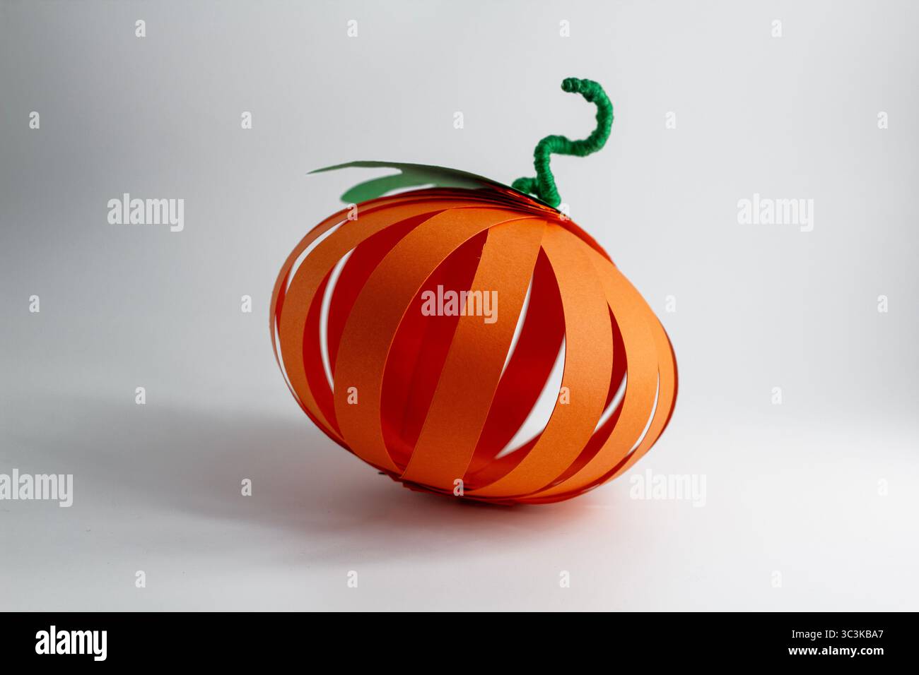 Tilted Pumpkin made up of paper strips, A shot of crafted paper pumpkin ...