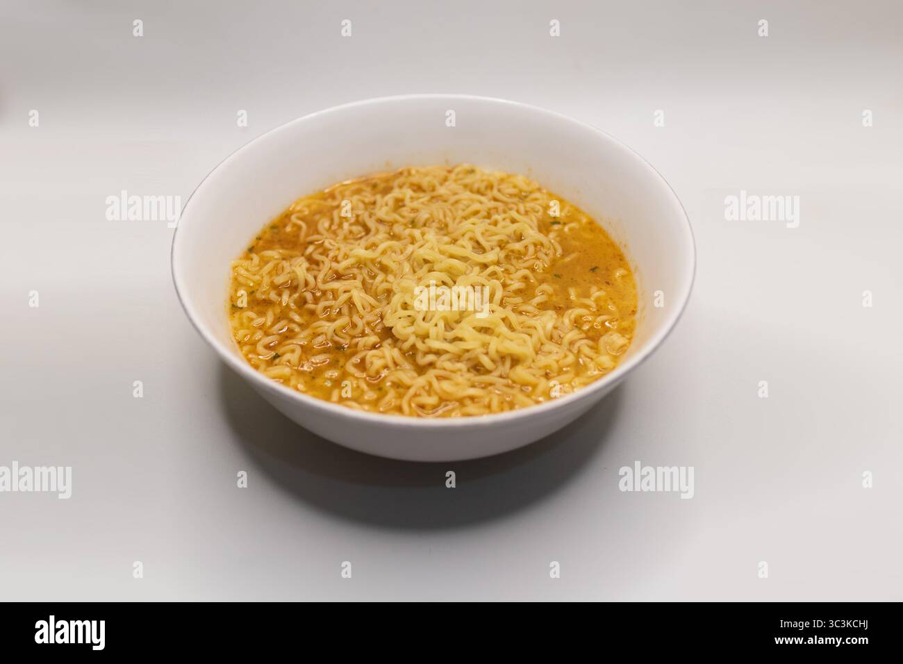 Yellow Instant Noodles in White Bowl with Spicy Broth Stock Photo - Alamy