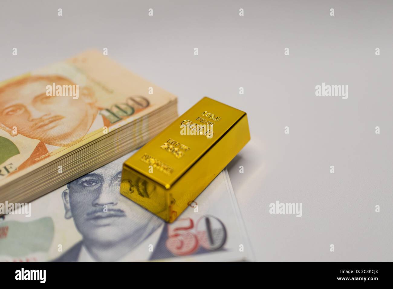 Gold Bar and Singapore Dollar Banknotes in Stack Stock Photo - Alamy