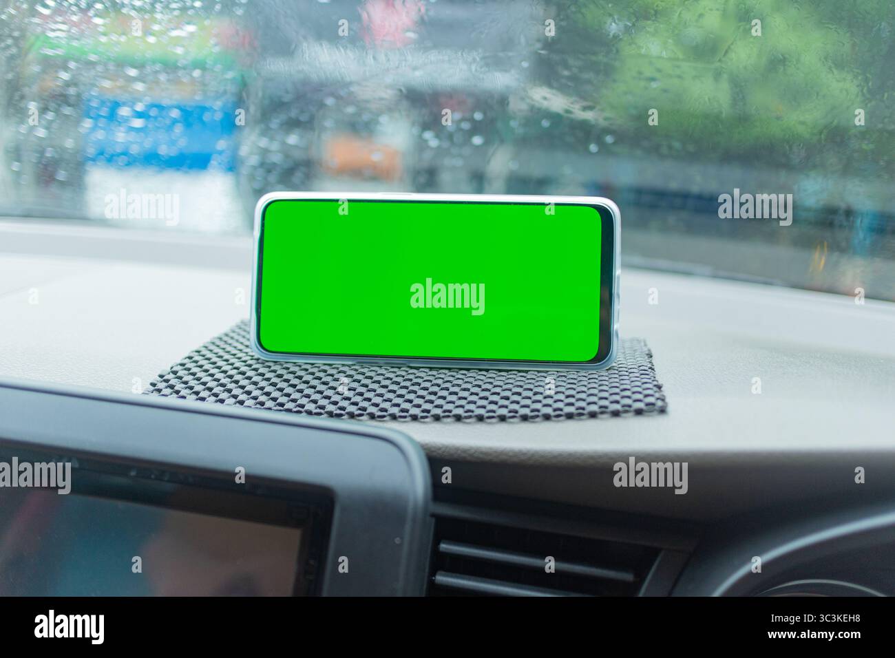 Smartphone with Green Screen Display on Dashboard in Car Stock Photo ...