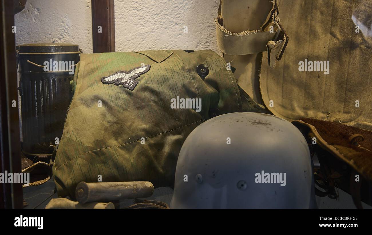 Display case with military equipment such as helmets and insignia, War ...