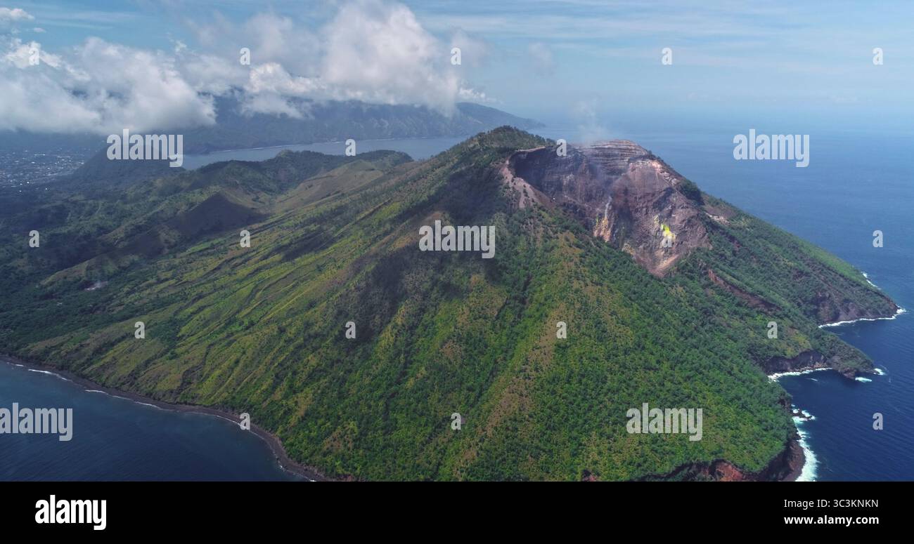 Aerial drone showing smoke rising from the crater of Mount Iliwerung ...