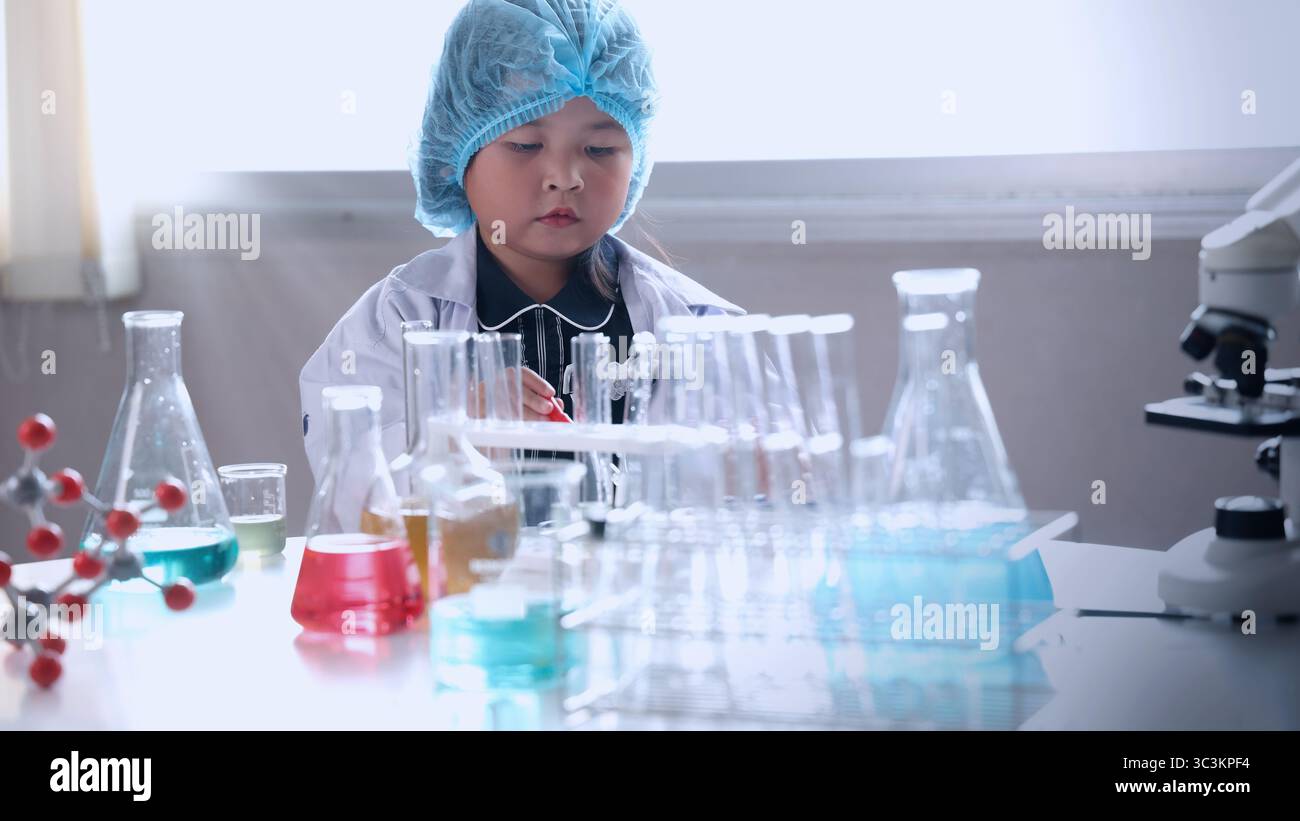 Kid and science. Child dress scientist learning conducts experiment in ...