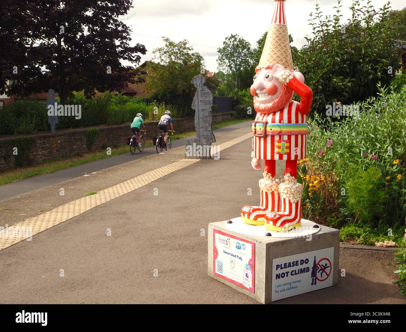 Two cyclists pass Sweet and Tidy Norbot at Warmley Waiting Room ...