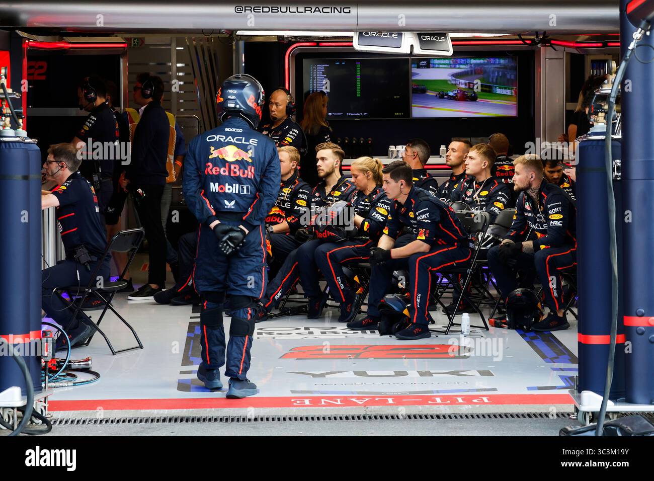 Red Bull crew watch the sprint race from the team garage ahead of the ...