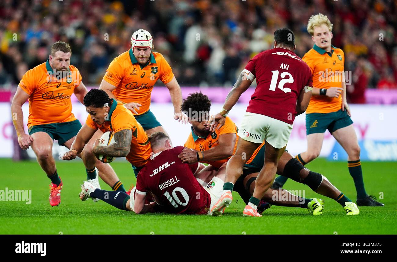 Len Ikitau of Australia is tackled by Finn Russell of the British and ...