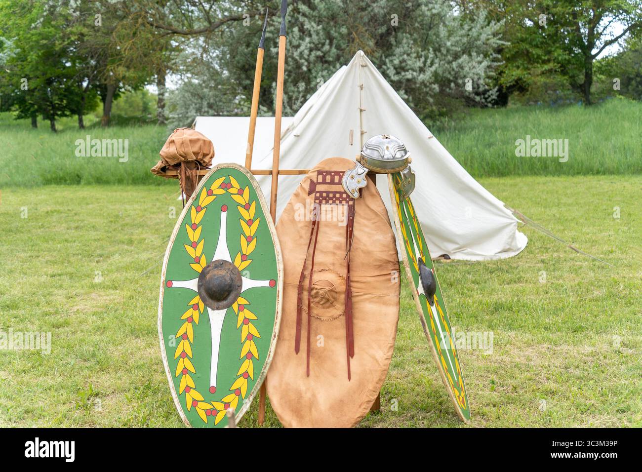 Late Roman green military shields and helmets in a historical camp ...