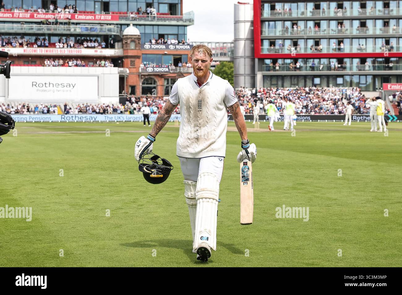 England captain Ben Stokes leaves the field of platy to a standing ...