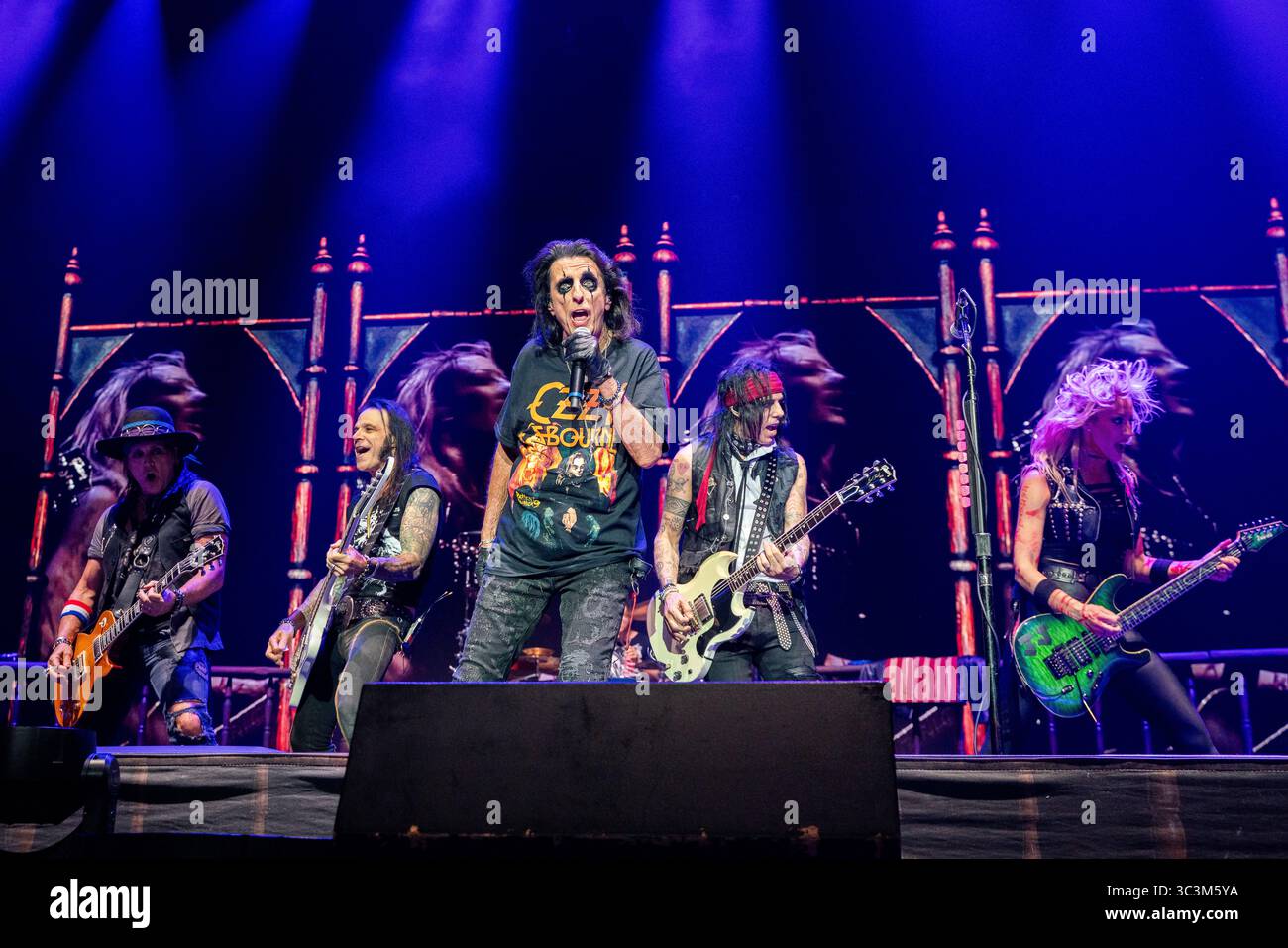Alice Cooper seen on stage with his touring band members Ryan Roxie ...