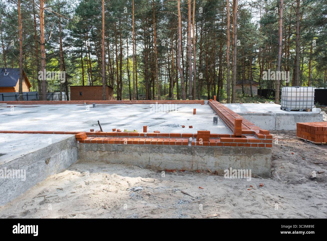 Concrete slab of foundation of house with laid pipes start of ...
