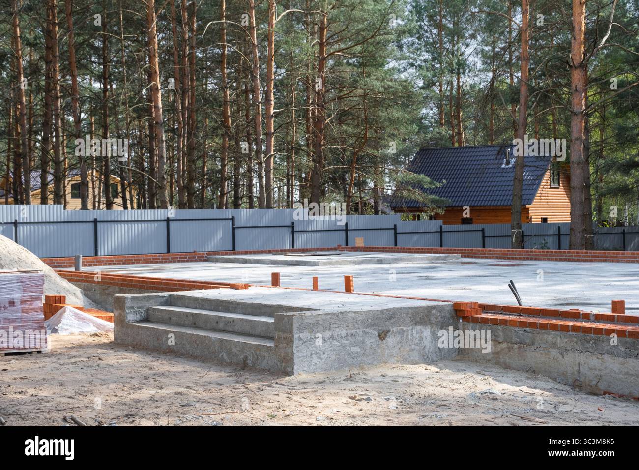 Concrete slab of foundation of house with laid pipes start of construction on project ...