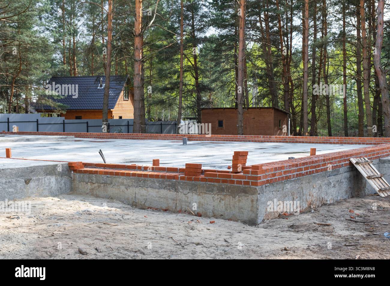 Concrete slab of foundation of house with laid pipes start of construction on project ...