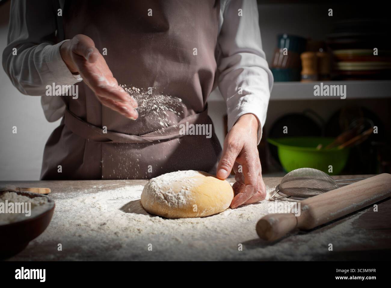 Baking concept. Caucasian female hands throwing flour at the dough ...