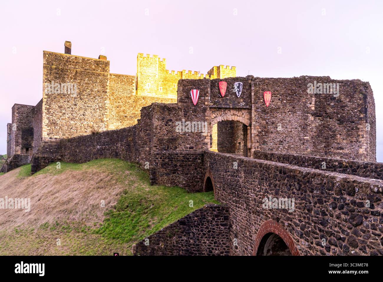 King's gate, Dover castle at dusk. The stone bridge to the gate and ...