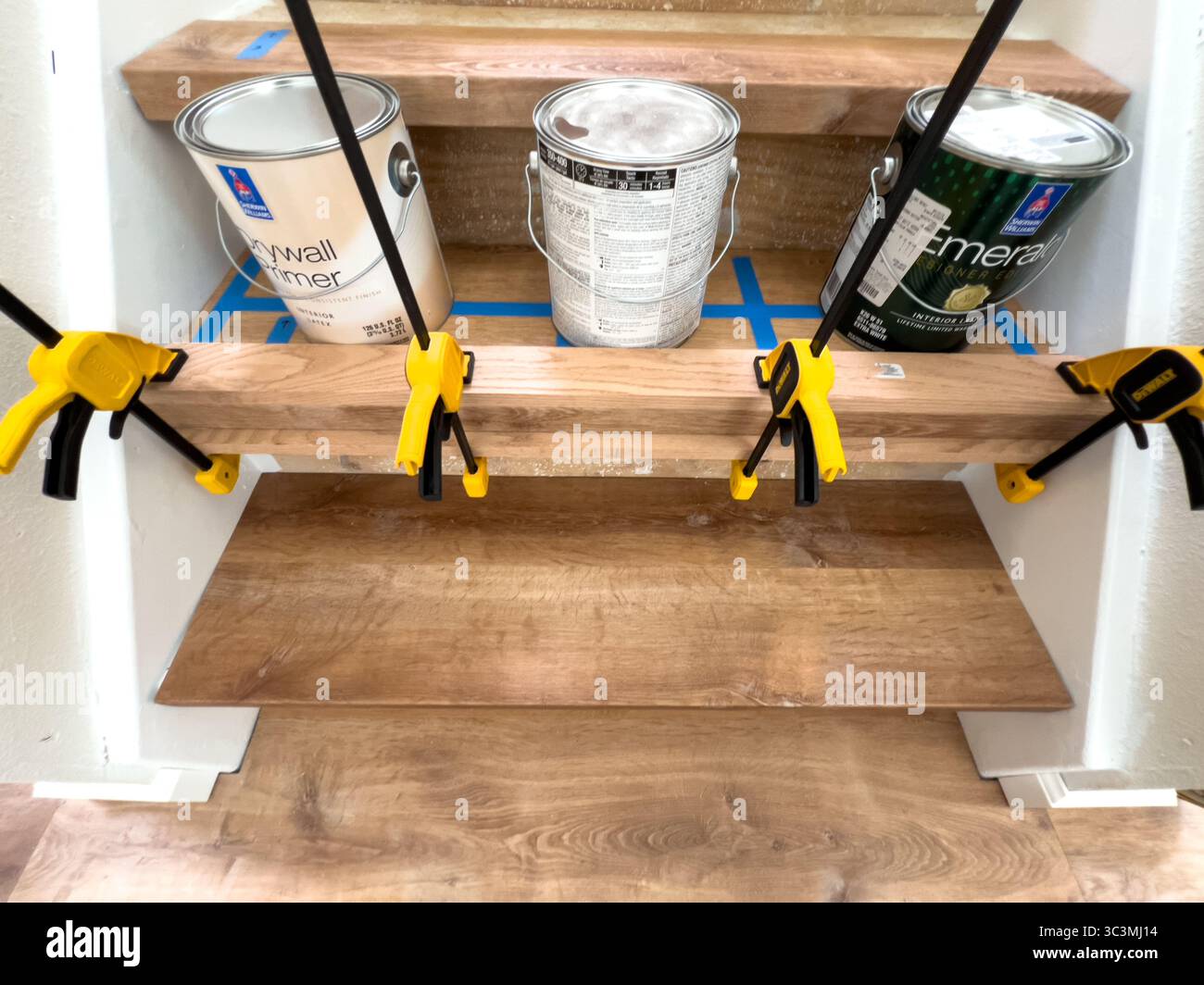 Closeup stair project with clamps and paint Stock Photo - Alamy