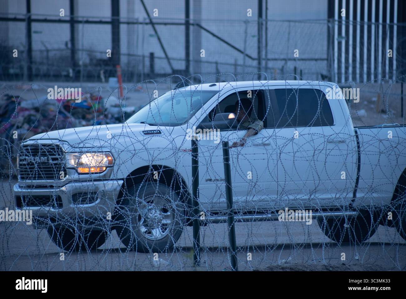 Security team monitors a border checkpoint near Ciudad Juarez at dusk ...