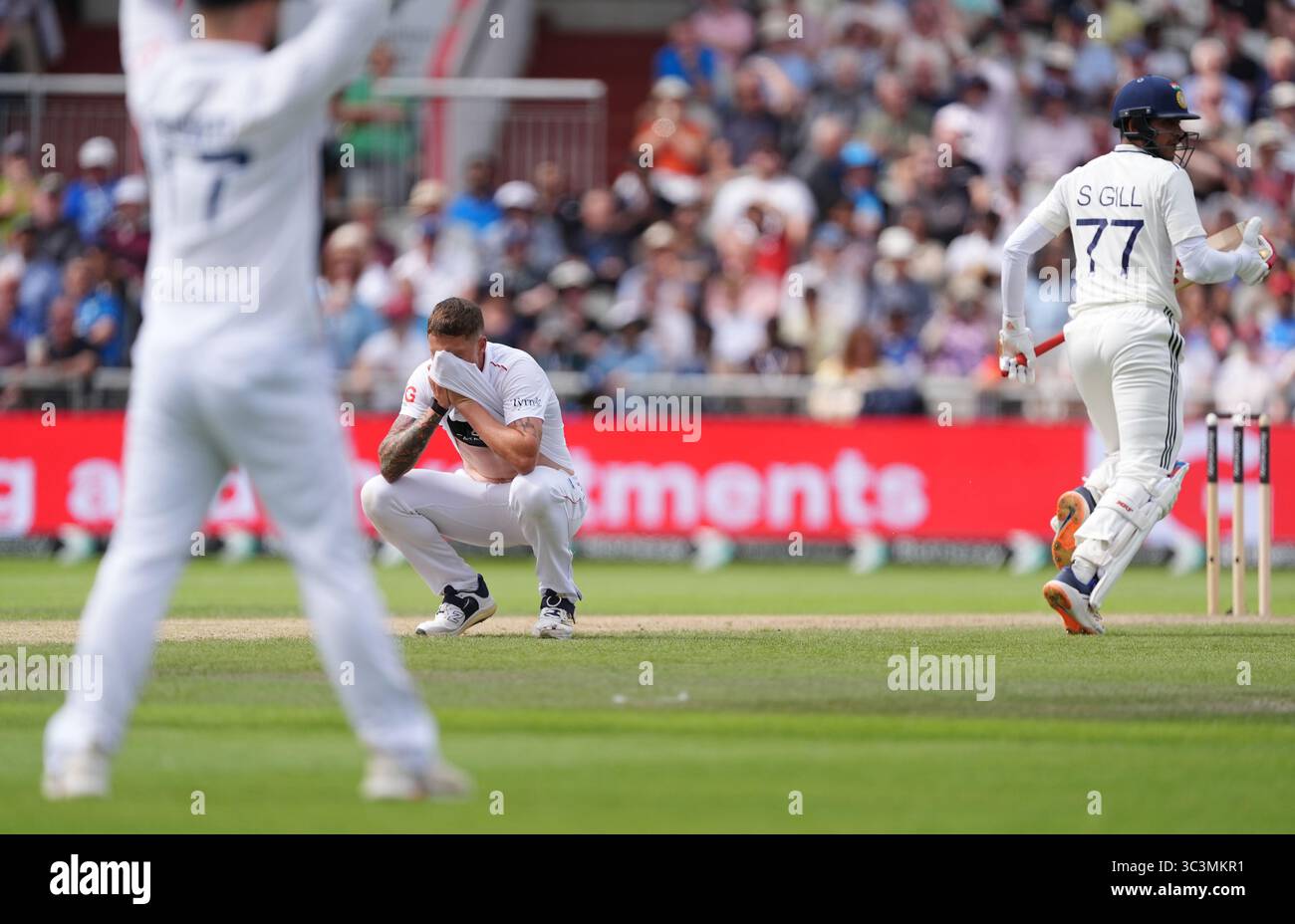 England's Brydon Carse (centre) reacts after a failed catch of India's ...
