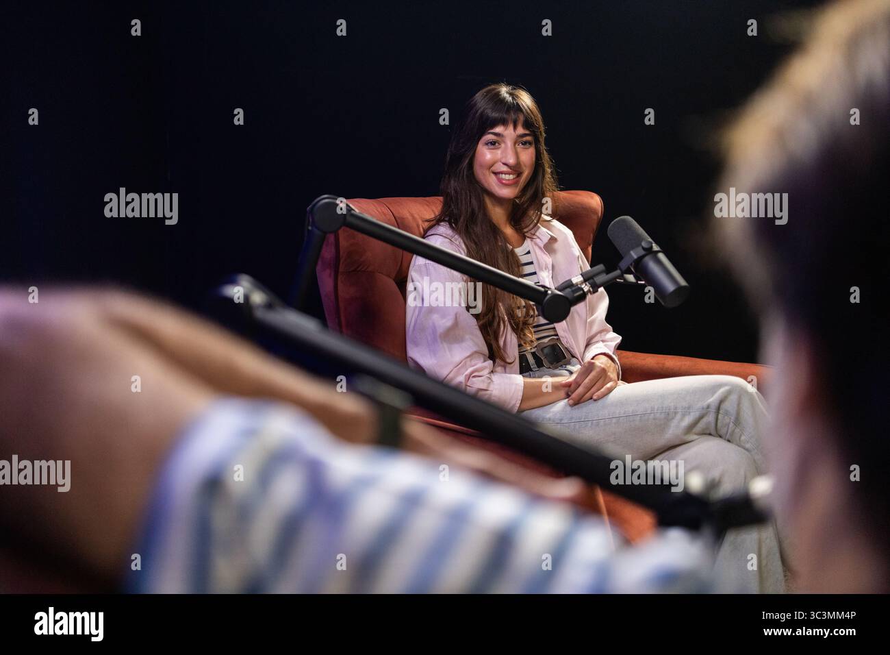 A vibrant podcast studio featuring hosts engaged in an insightful ...