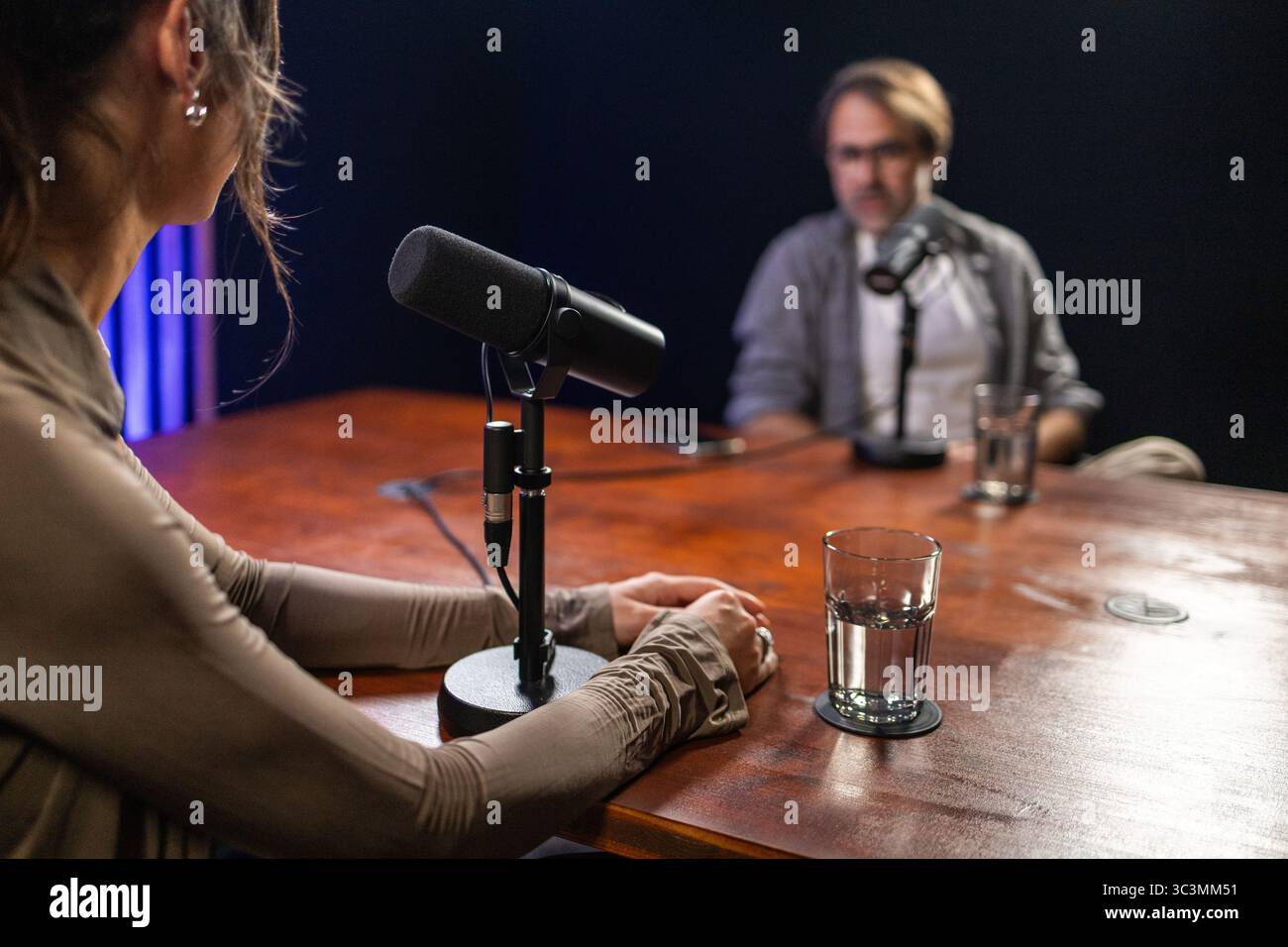A professional podcast recording studio setup featuring microphones and ...