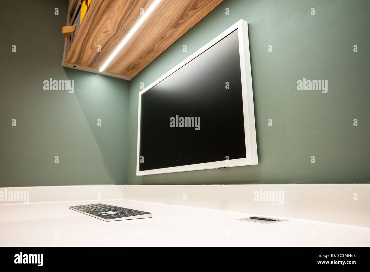 A sleek home office features a minimalist design with a wall-mounted ...