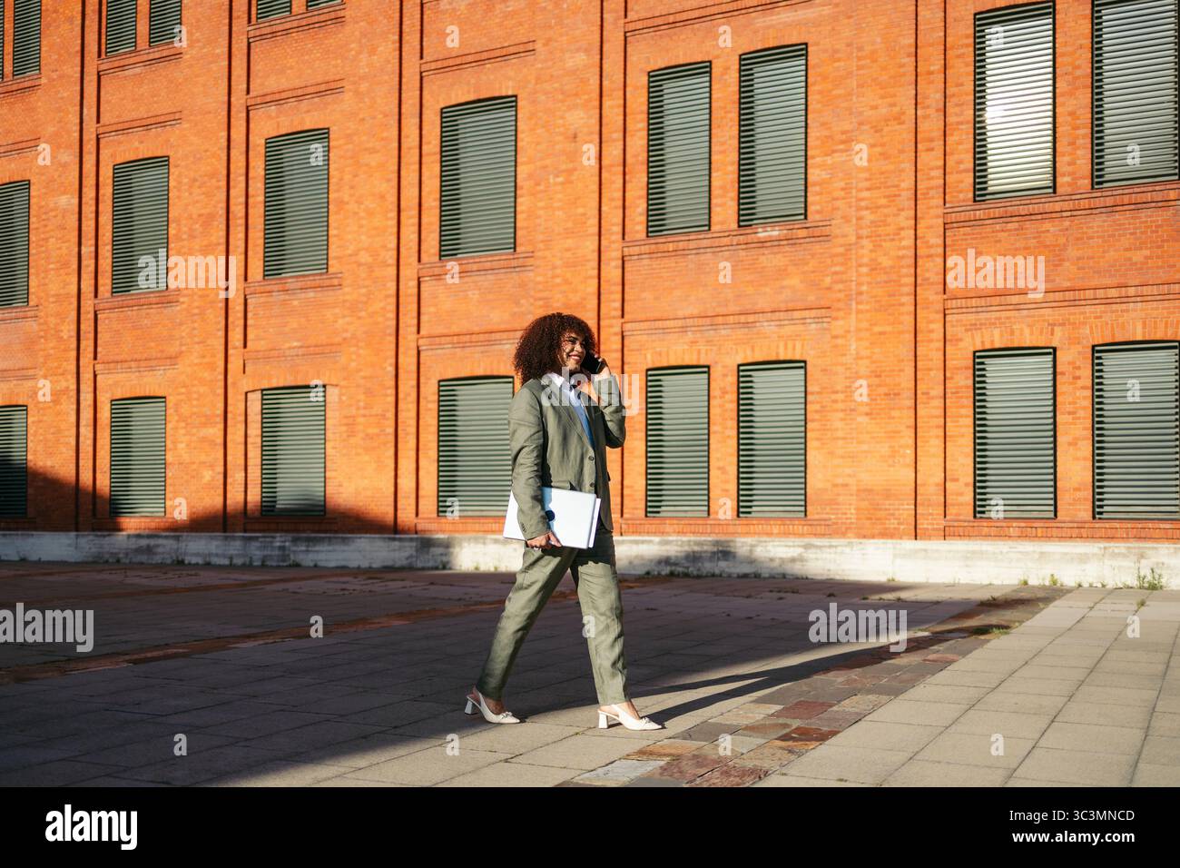 Professional trans woman confidently walks hi-res stock photography and ...
