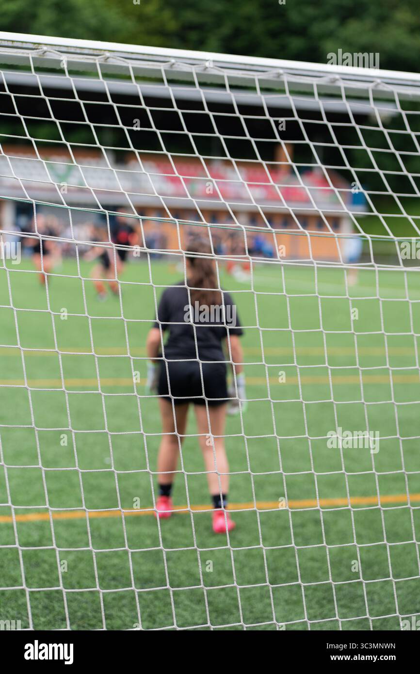 Back unrecognizable view of an anonymous female soccer goalkeeper in ...