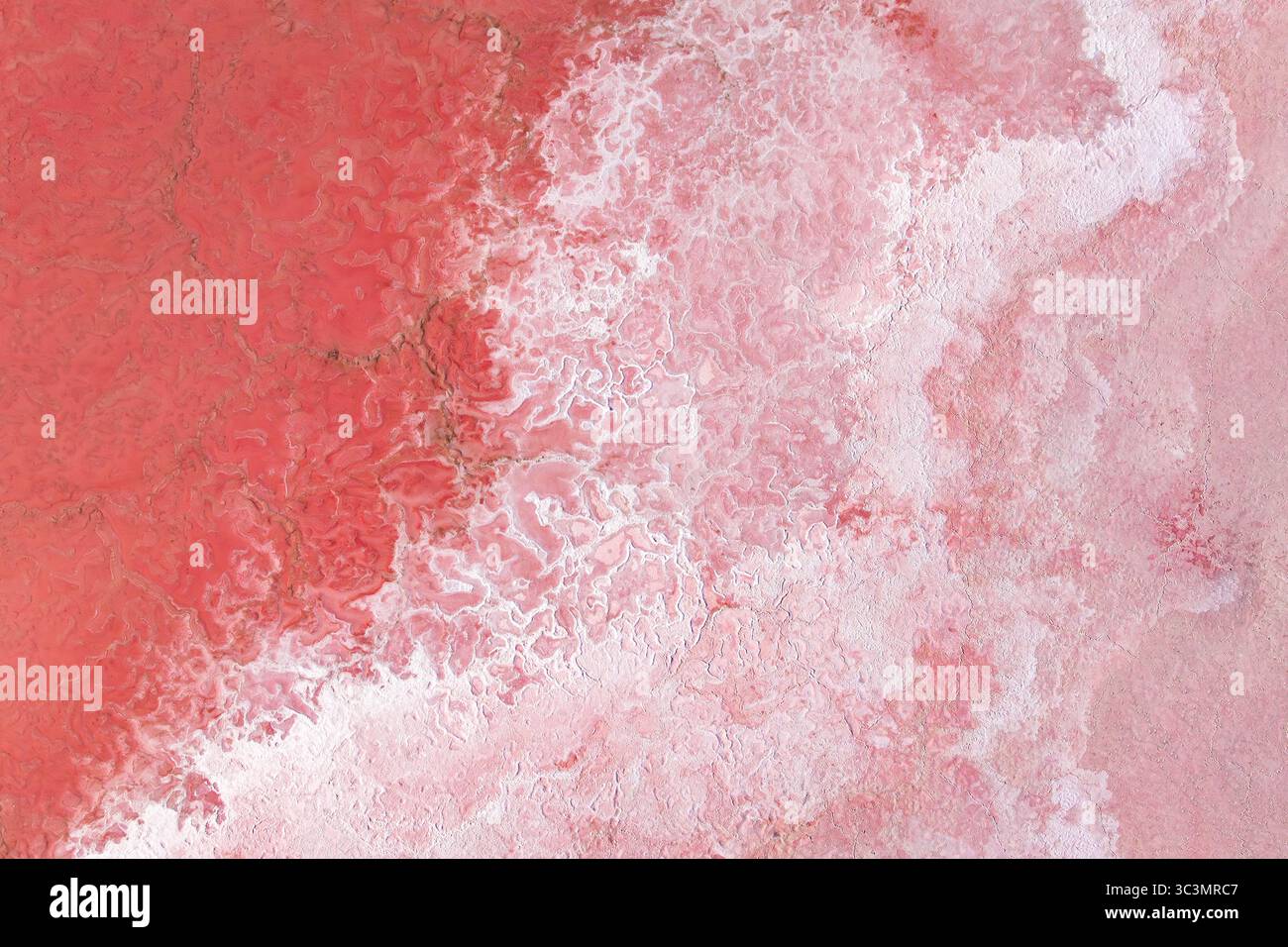 Aerial view captures a stunning red salt lagoon, showcasing intricate ...