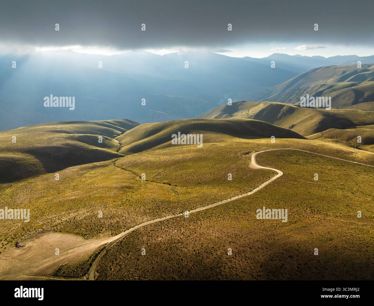 A breathtaking aerial view of golden hills in Jujuy, Argentina, under a ...