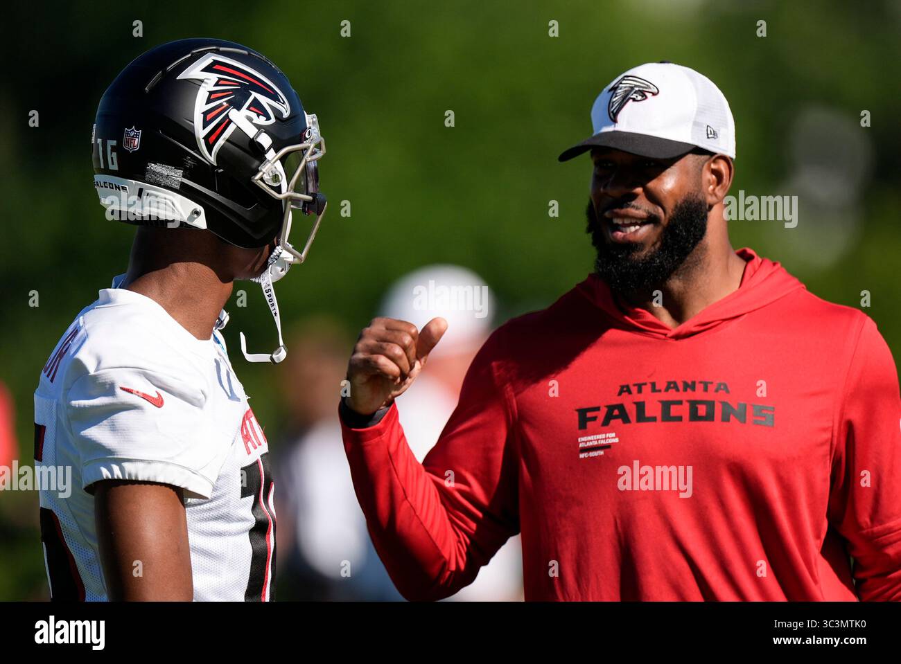 Atlanta Falcons DJ Chark Jr. speaks to tight ends coach Kevin Koger ...