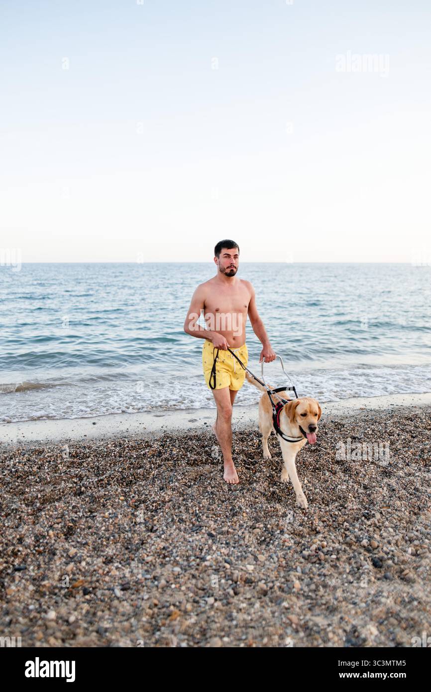 The blind guide walks into the water hi-res stock photography and ...