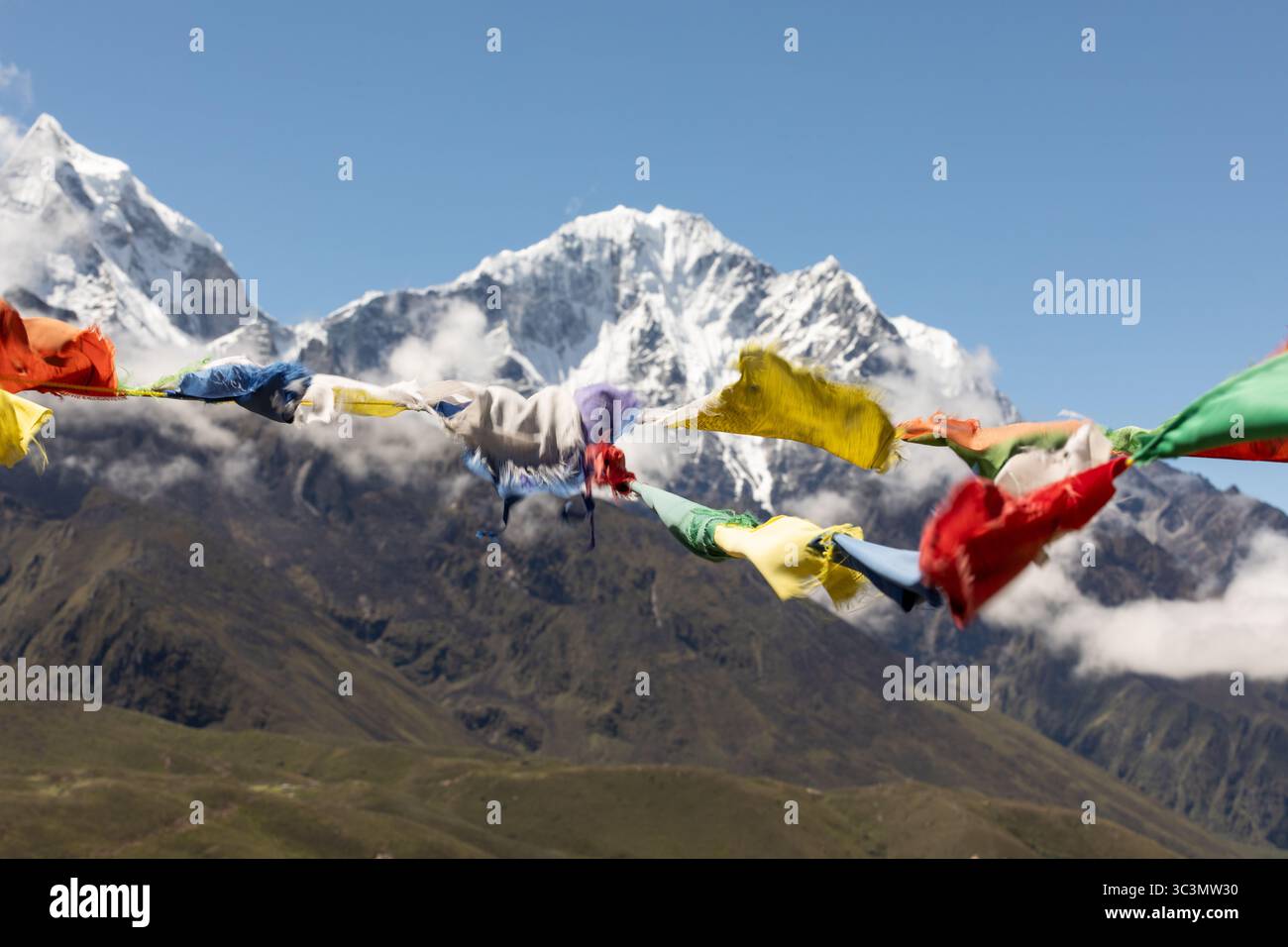 Colorful prayer flags flutter against the backdrop of the majestic ...