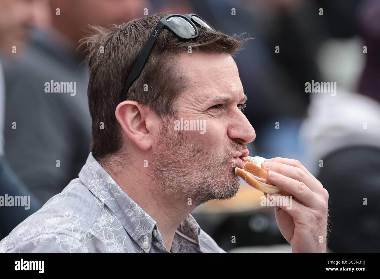 A fan tucks into a ham sandwich during the 4th Rothesay Test Match ...