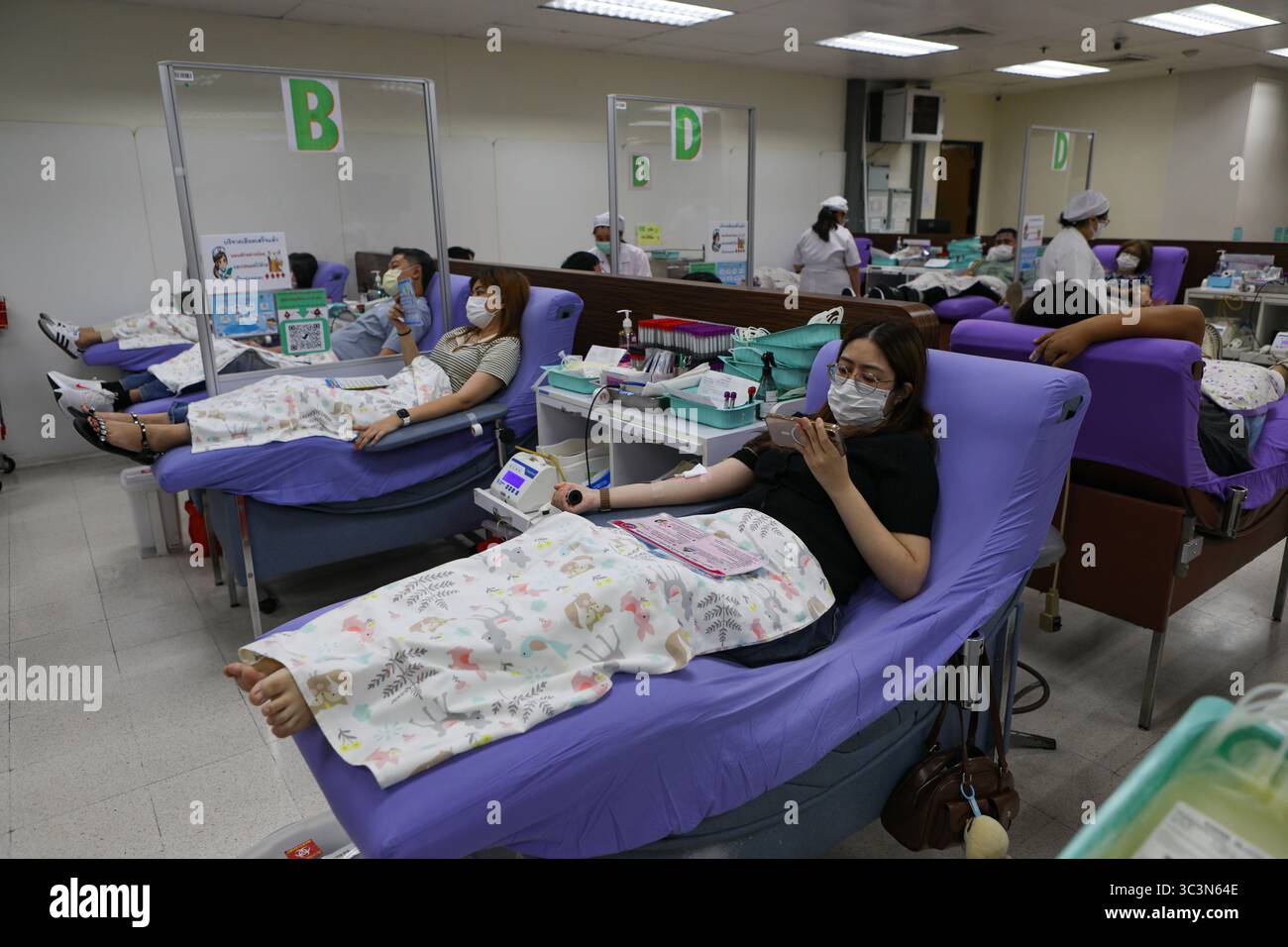People gather to donate blood at the National Blood Center of the Thai ...