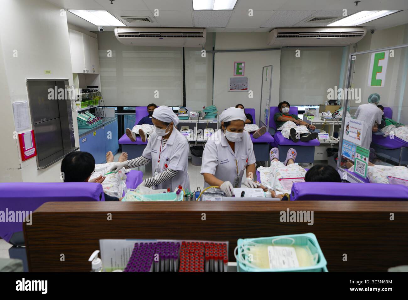 People gather to donate blood at the National Blood Center of the Thai ...