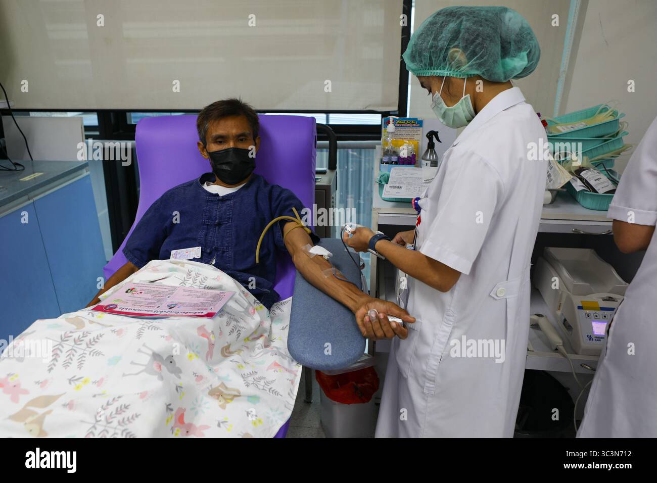 People gather to donate blood at the National Blood Center of the Thai ...
