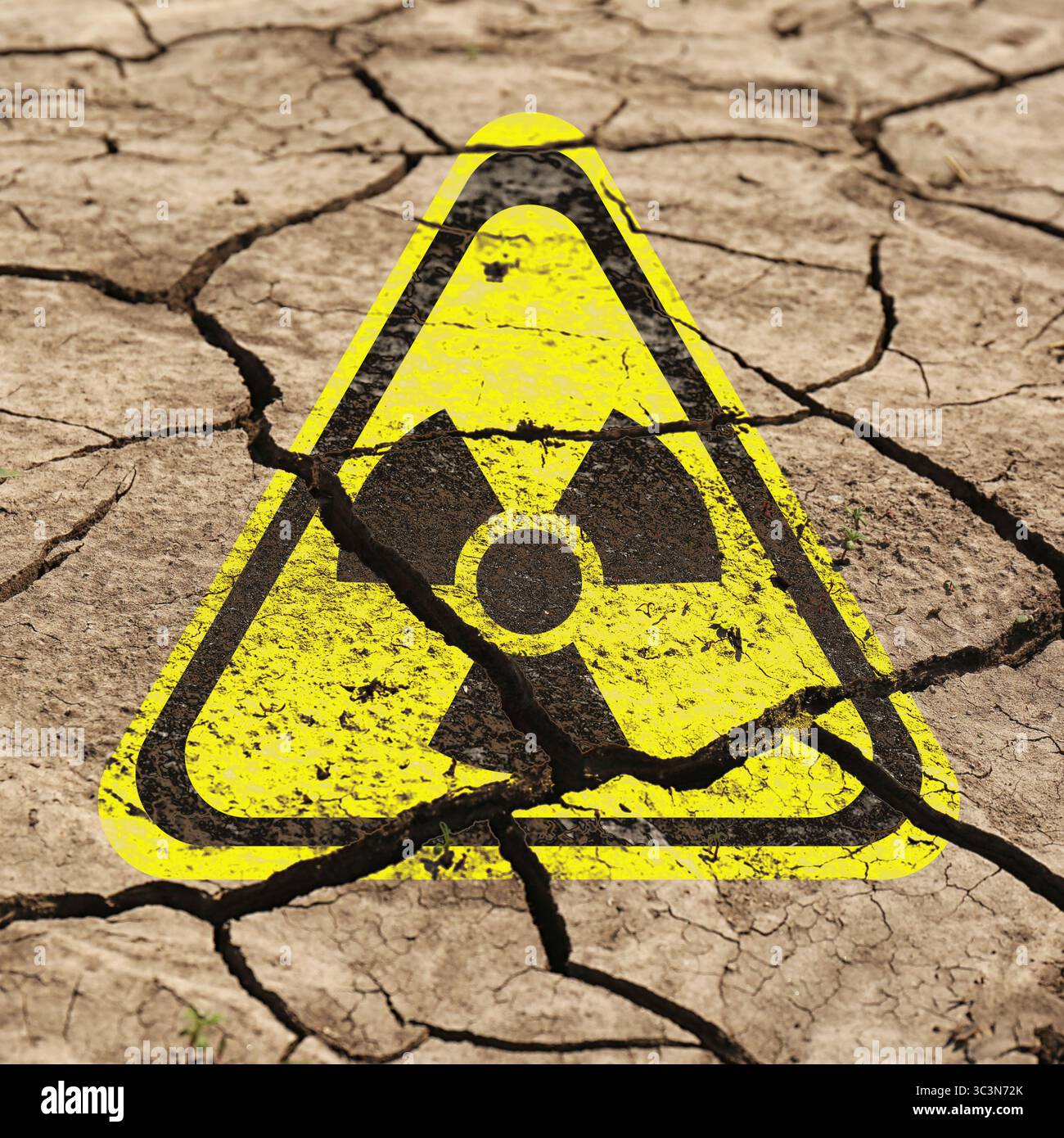 Yellow radioactive sign on cracked dry earth, closeup. Radiological ...