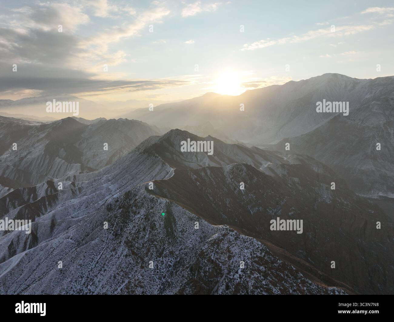 An breathtaking aerial view of layered mountain ranges partially ...
