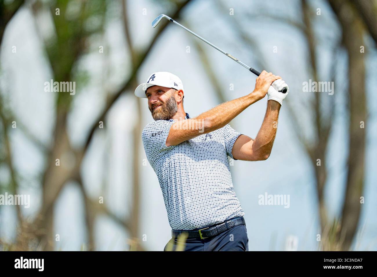 Captain Dustin Johnson of 4Aces GC hits his shot from the fifth tee ...
