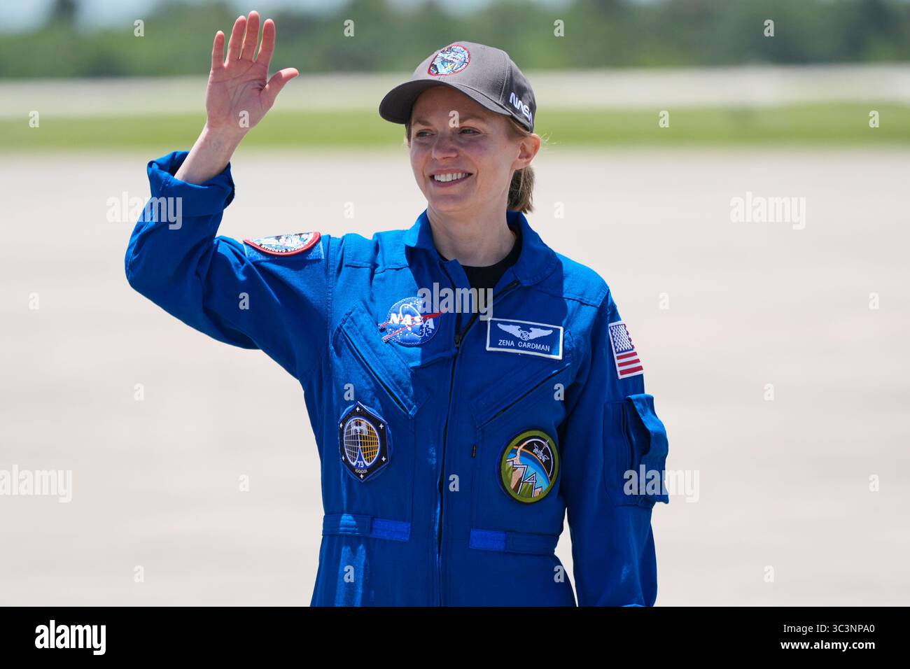 Commander Zena Cardman, of NASA, waves to media after arriving at the ...