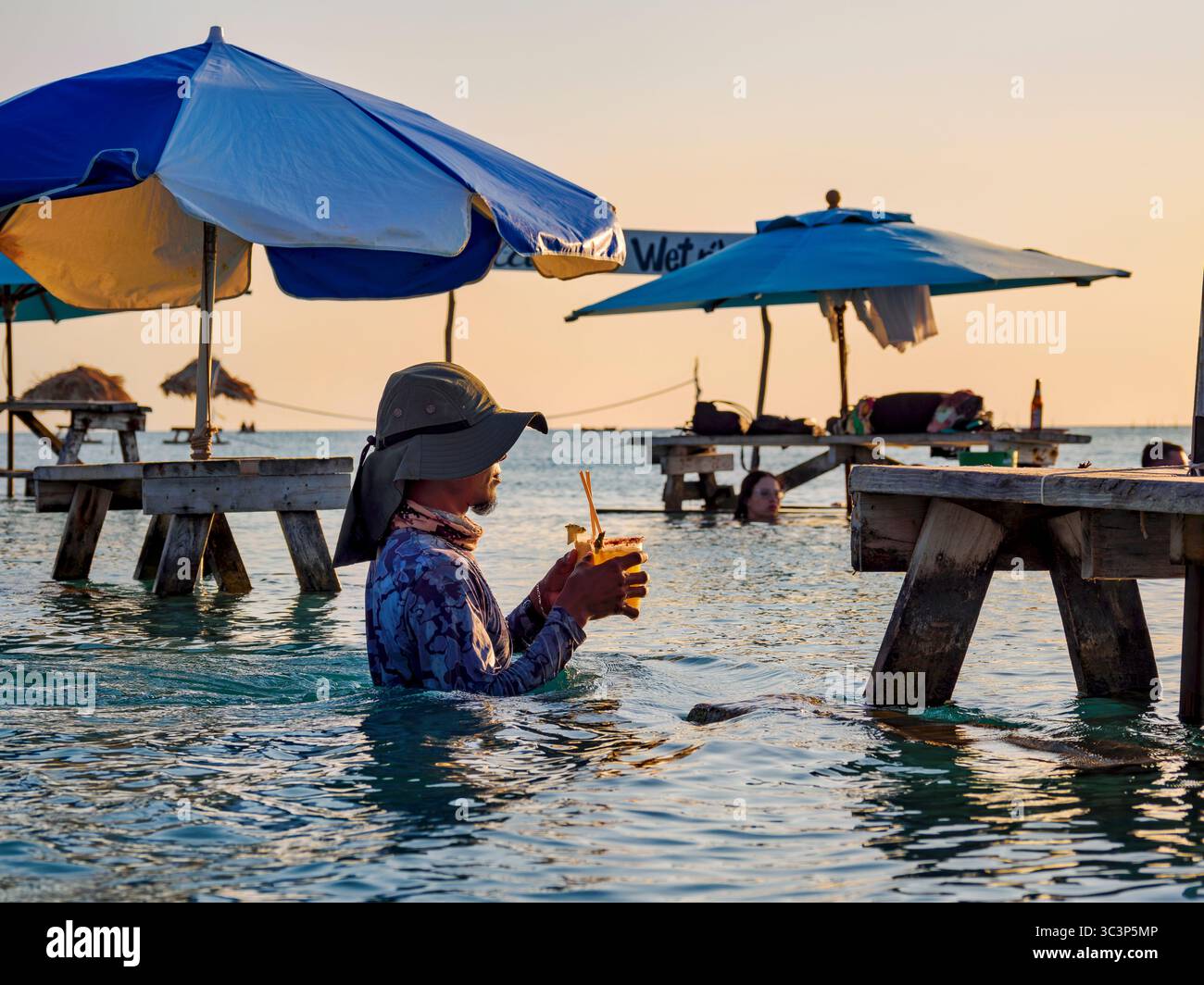 Tables in the water at Blue Bayou Restaurant, Secret Beach, Ambergris ...